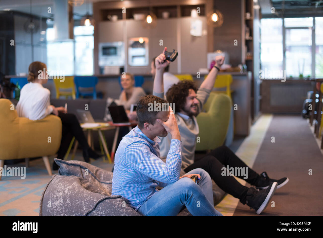 Work hard play hard. Workers Playing computer games in creative startup ...