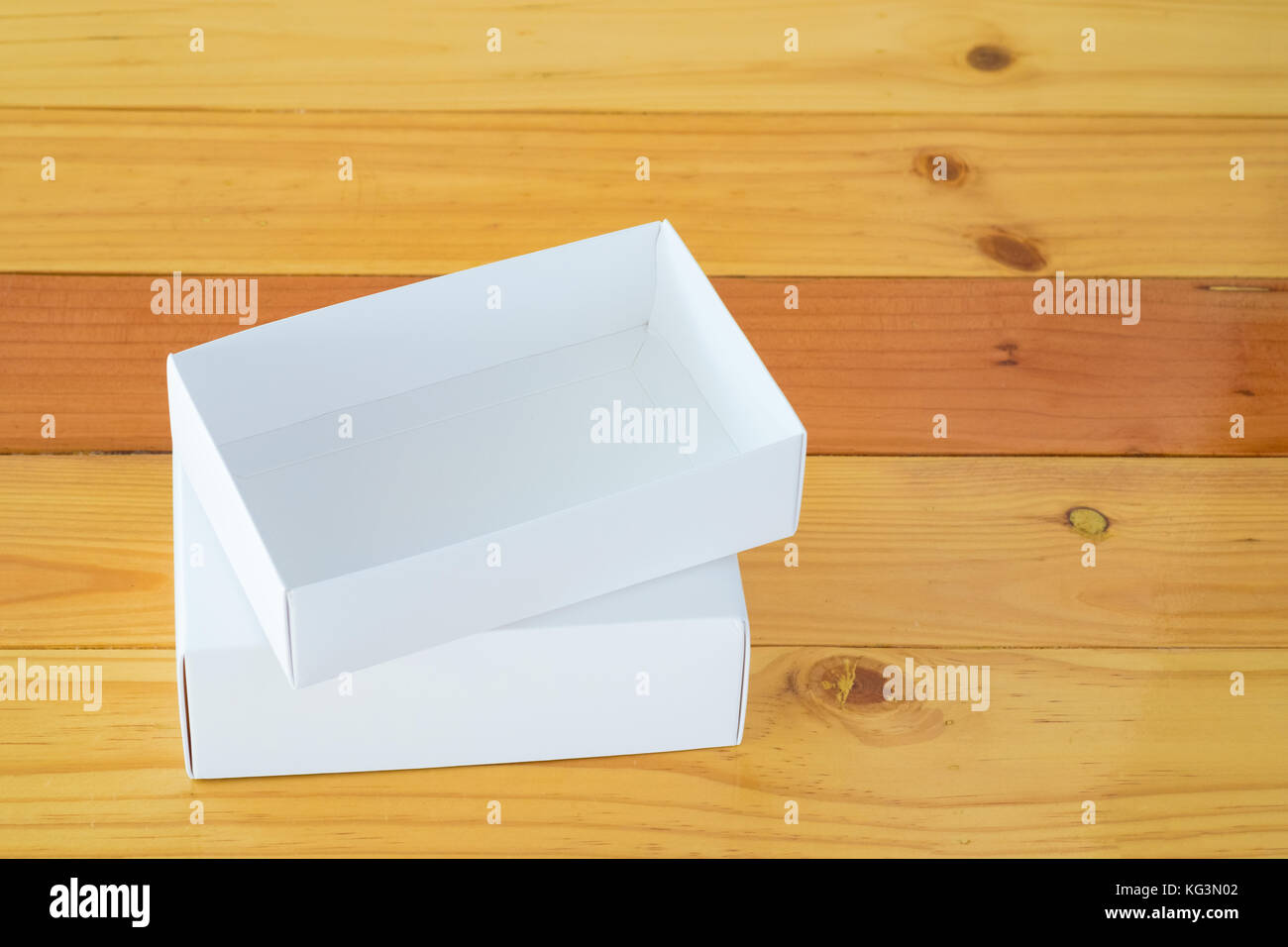 Empty white gift box for mock up on bright wooden table with copy space ...