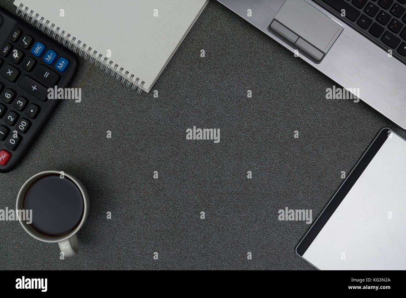 Laptop computer or notebook, calculator and cup of coffee on gray color ...