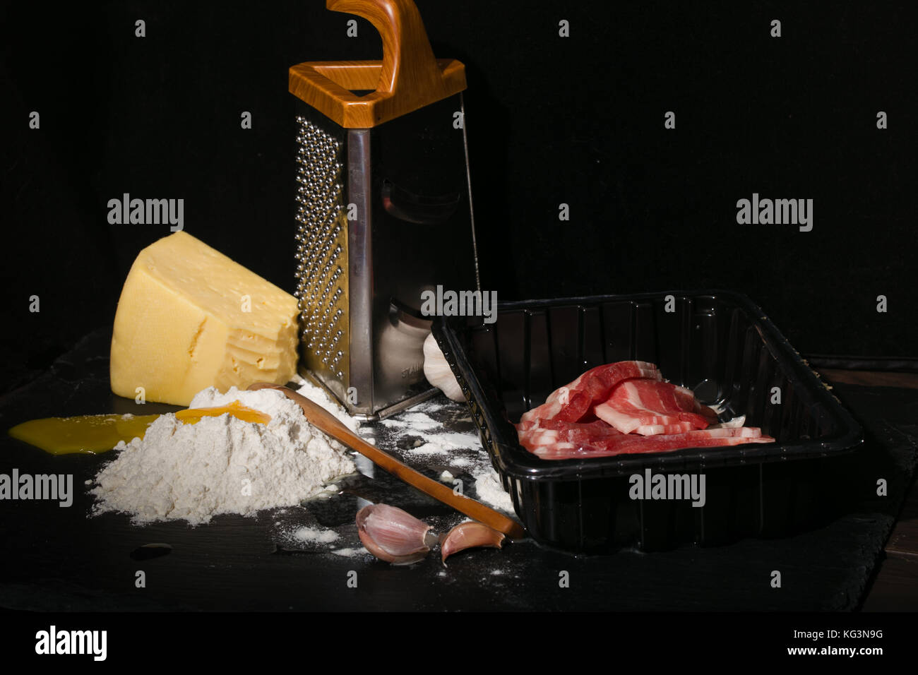 Crude products on a kitchen table. Crude bacon, the broken egg and ...