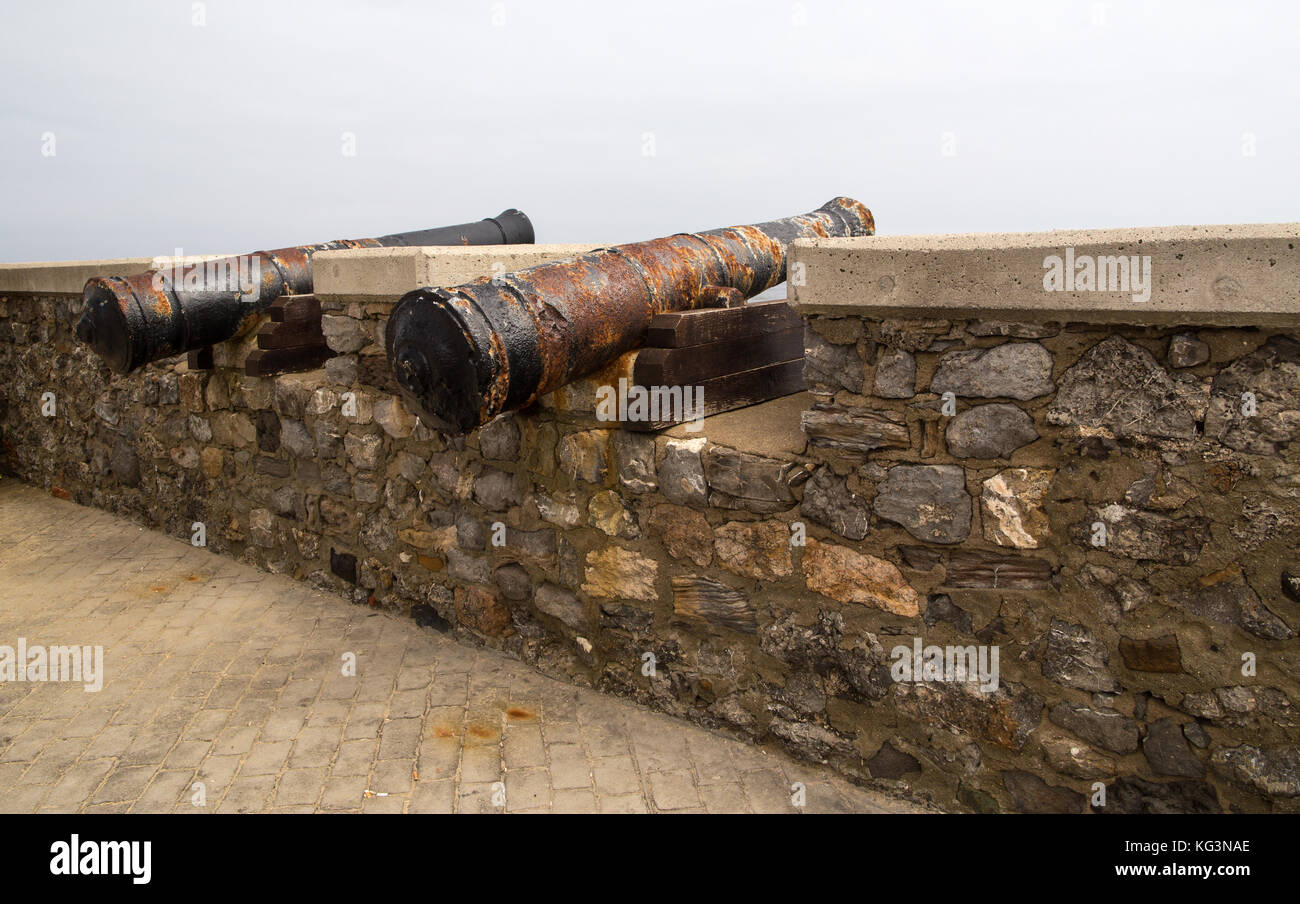 Ancient guns on a fortress wall. Guns are covered with a rust ...
