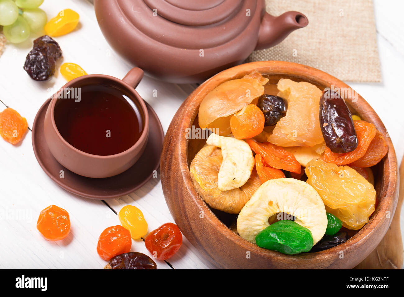 Tea drinking with dried fruit from pottery. Rural style, close up ...
