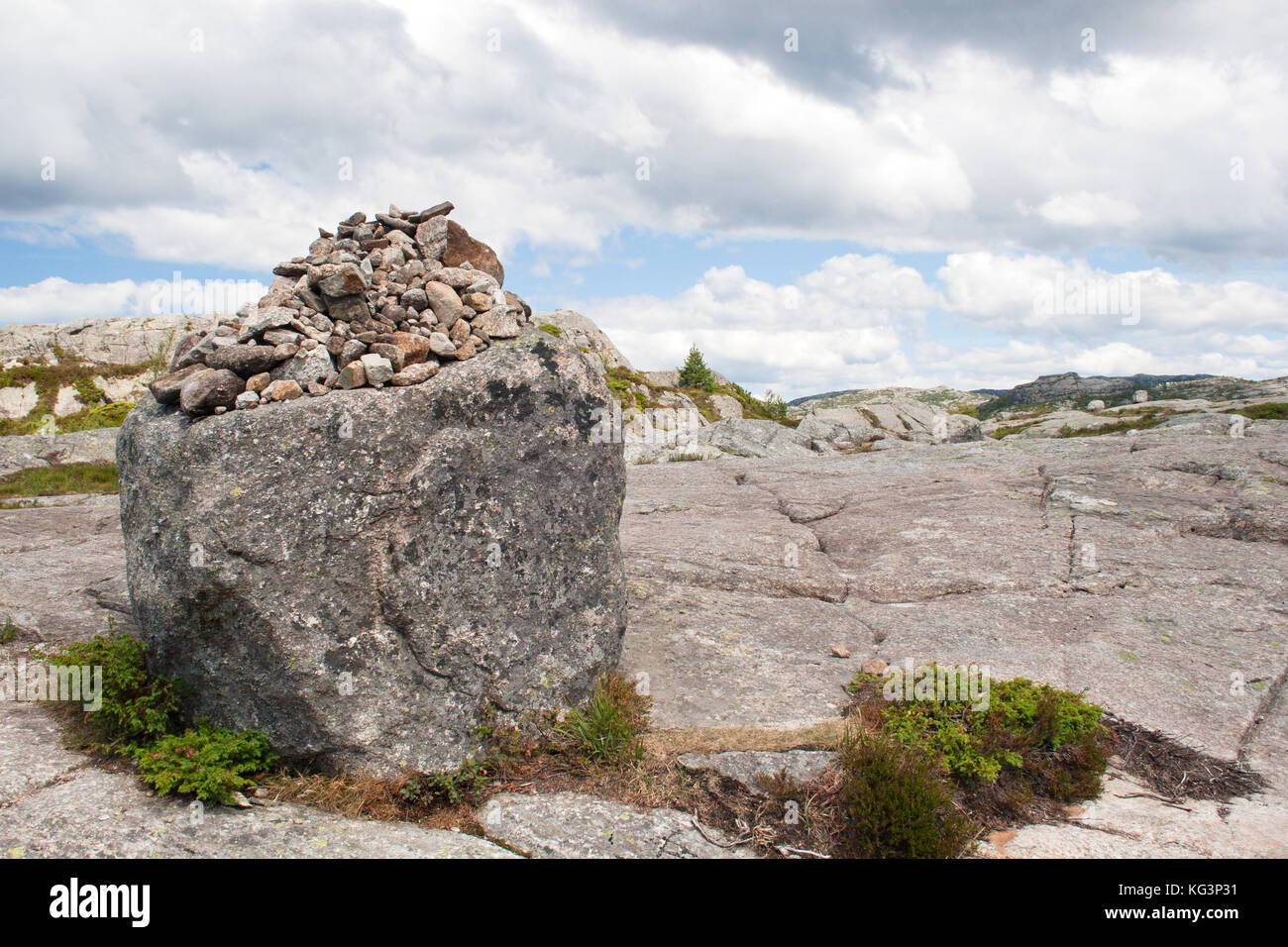 Norway. Stones on a tourist track. A huge boulder and a heap of small ...