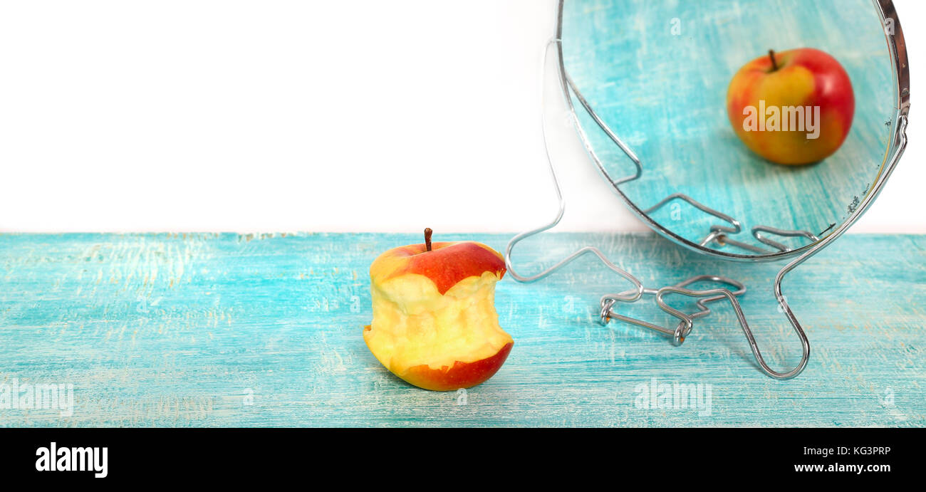 Bit of apple and reflection in a mirror of the whole apple. The taken a ...