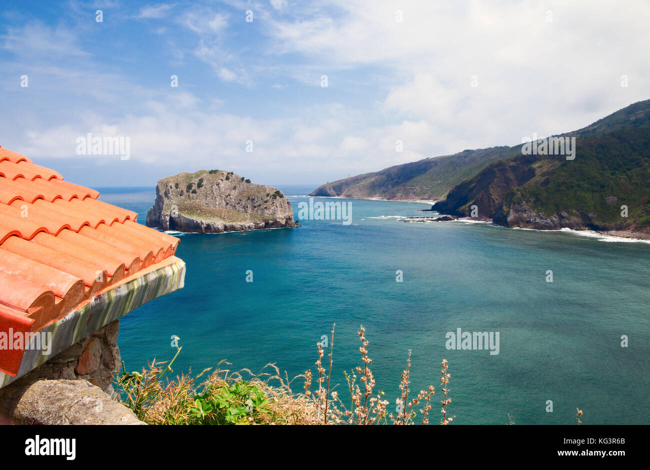 rocky ocean coast and part of a roof. A view of the ocean in summer ...