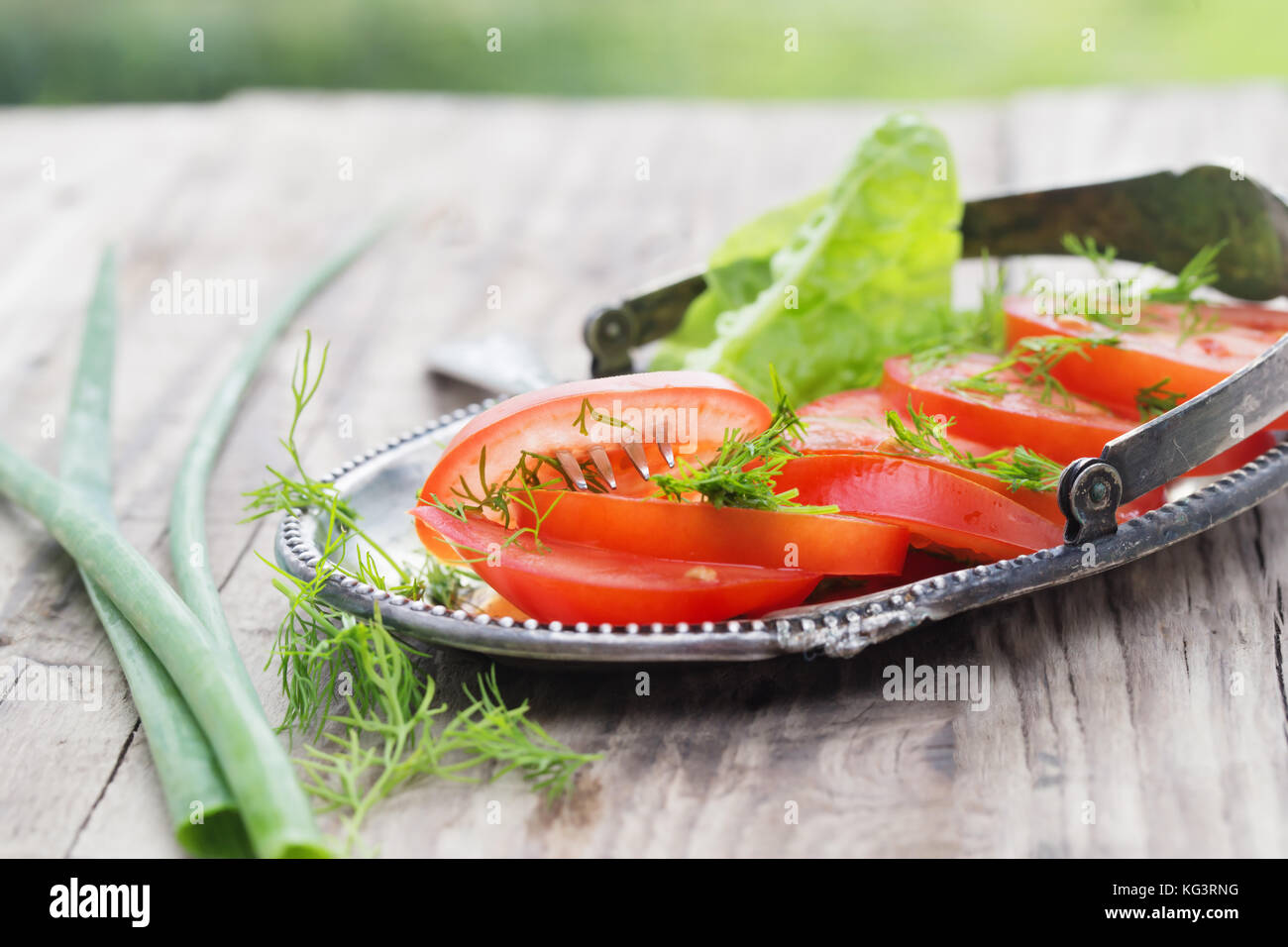 Snack from tomato in rural style. Segments of tomatoes with green ...