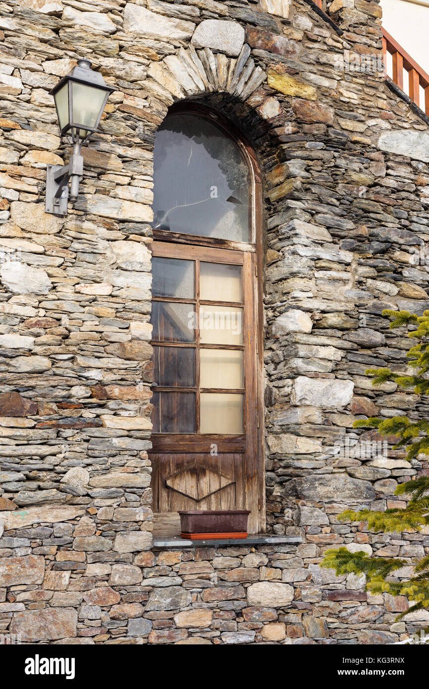 Wooden window in the ancient stone house. A fragment of the traditional ...