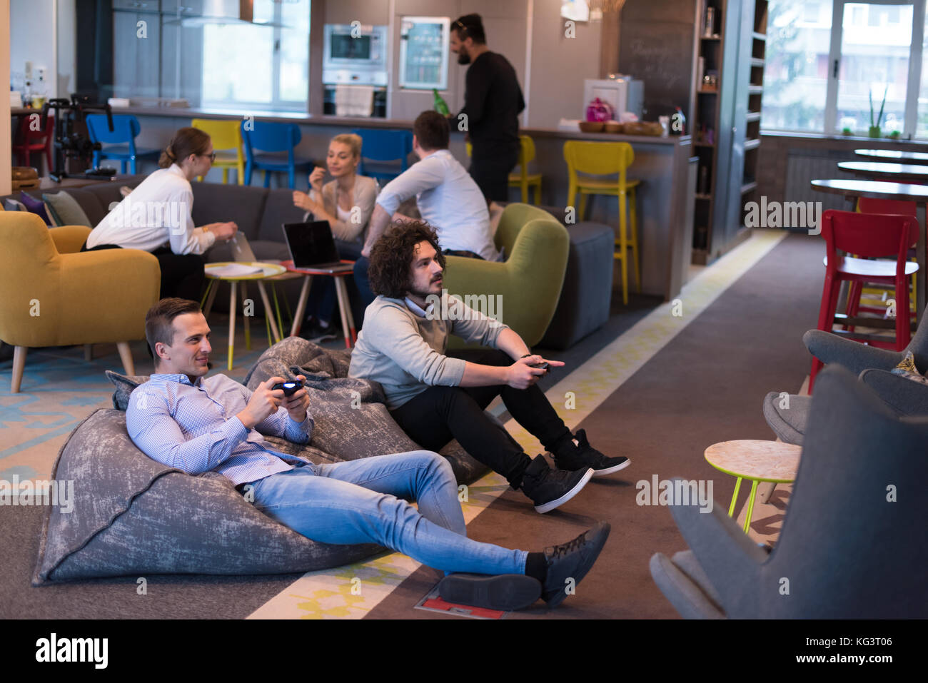 Work hard play hard. Workers Playing computer games in creative startup ...