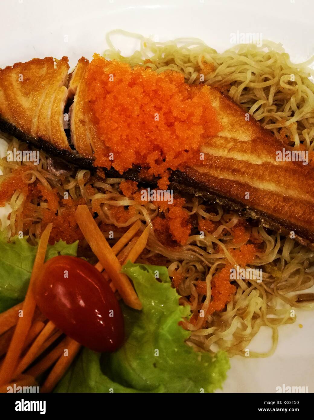 fried salmon with shrimp eggs (ebiko) on dry noodle plate fusion food ...