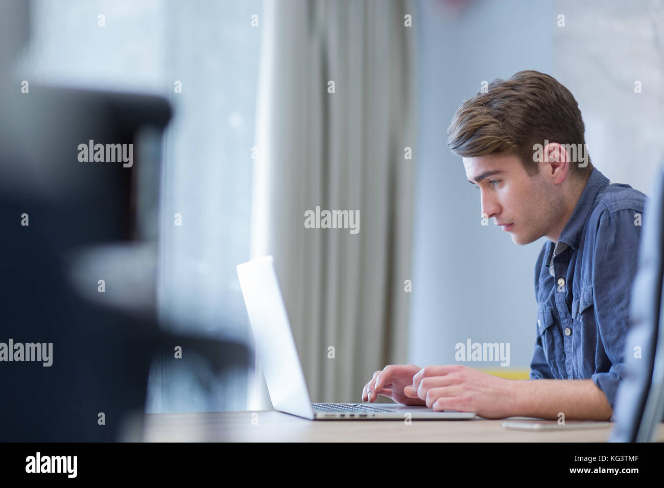 Young Entrepreneur Freelancer Working Using A Laptop In Coworking space ...