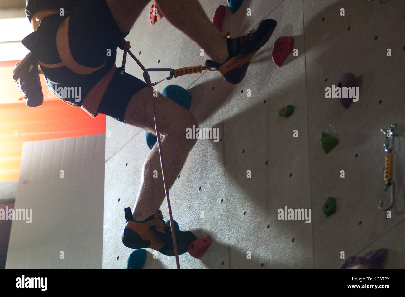 Man Climbing with Ropes on Climbing Wall Stock Photo - Alamy