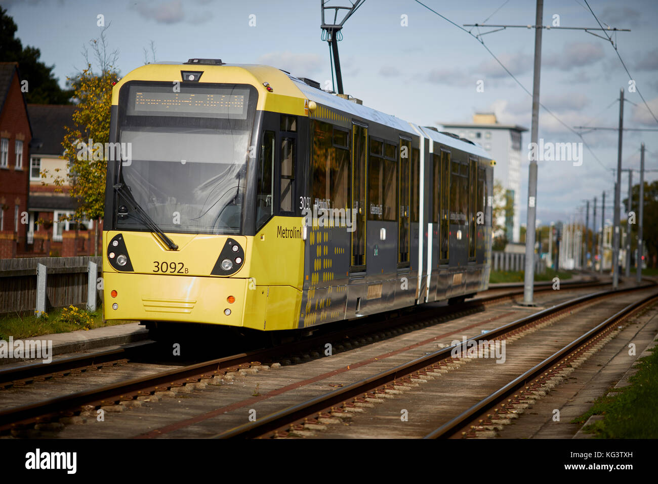 A yellow Metrolink Manchester tram at Brownlwy Road, Benchill ...