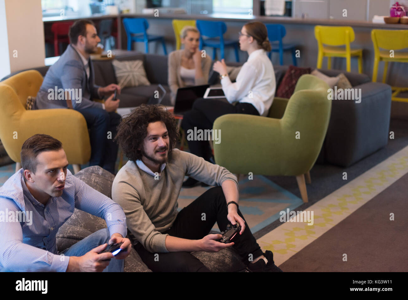 Work hard play hard. Workers Playing computer games in creative startup ...