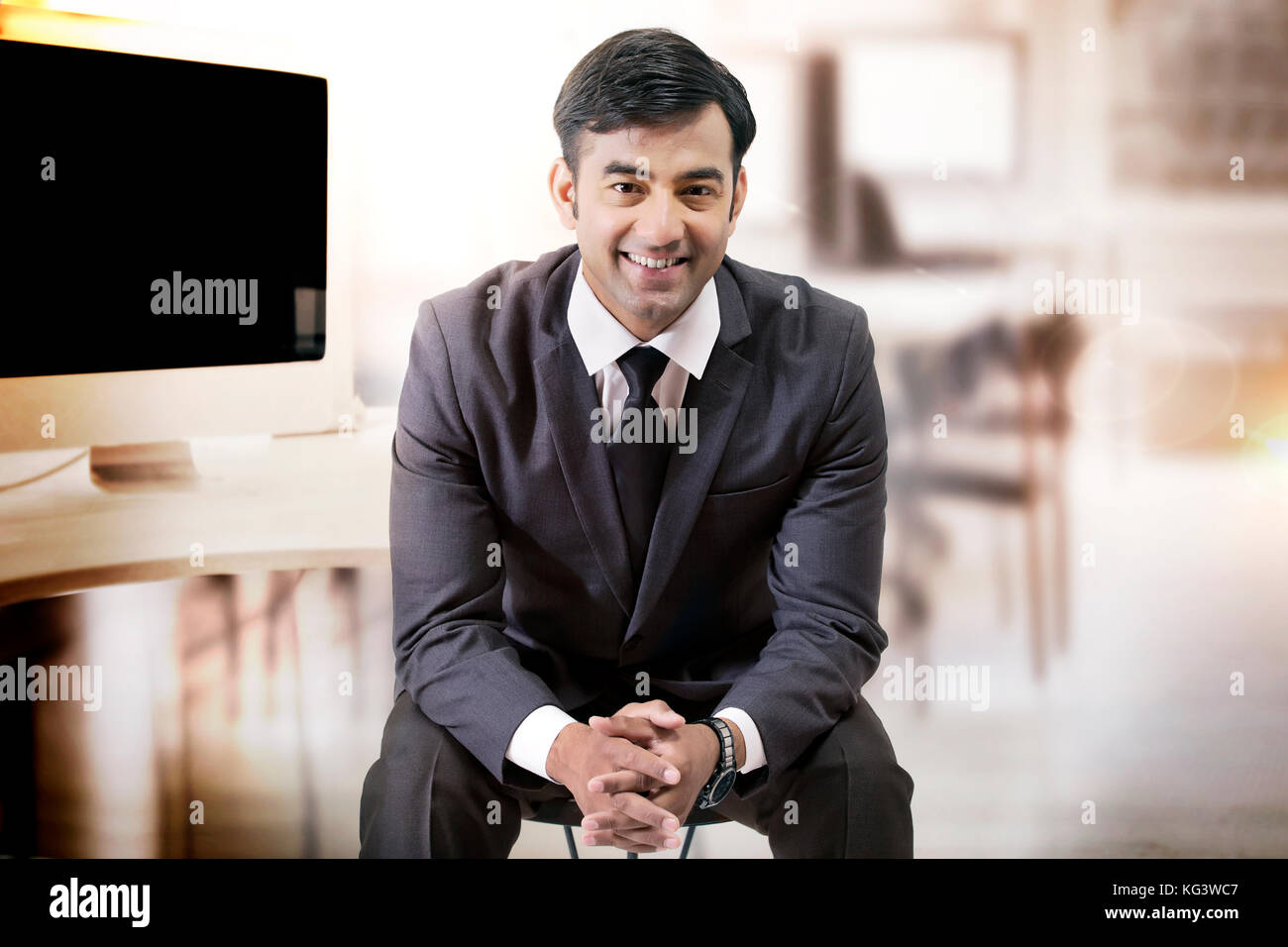 Portrait of businessman sitting in office Stock Photo - Alamy