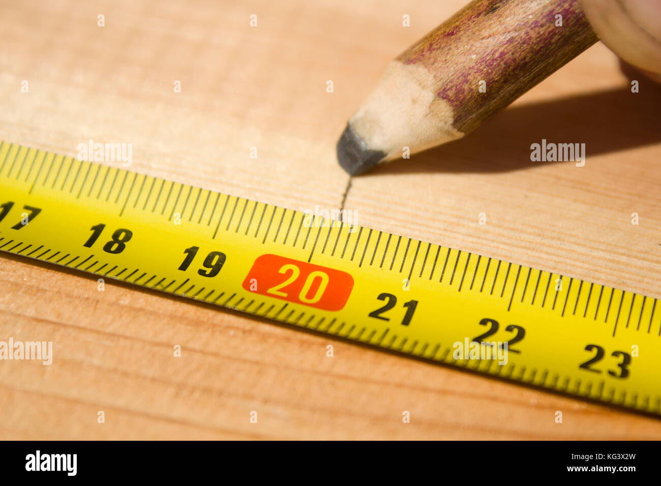 The carpenter measures the distance using a measure and marks with a ...