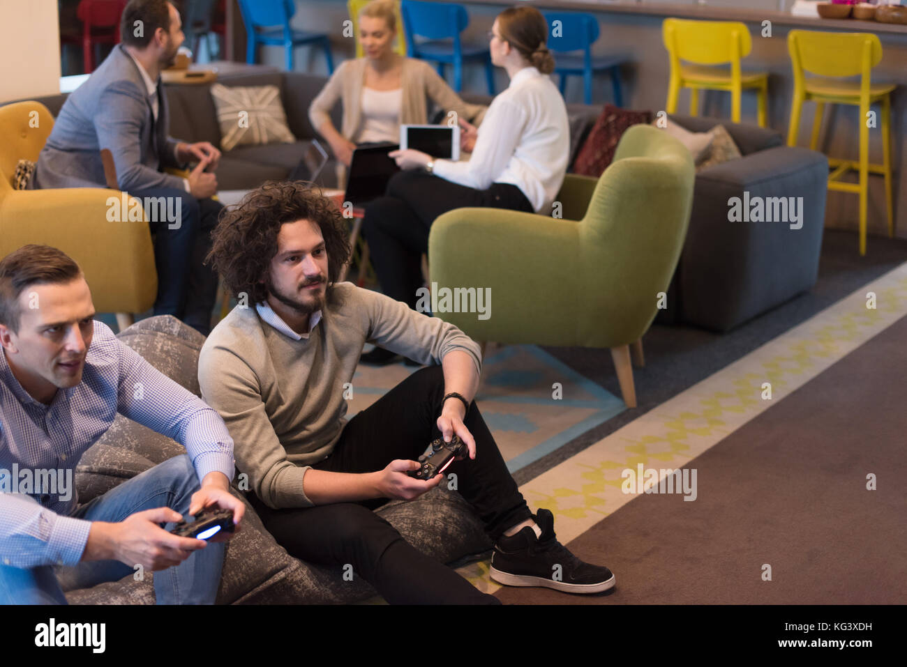 Work hard play hard. Workers Playing computer games in creative startup ...