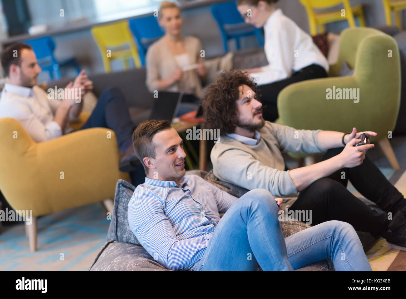 Work hard play hard. Workers Playing computer games in creative startup ...