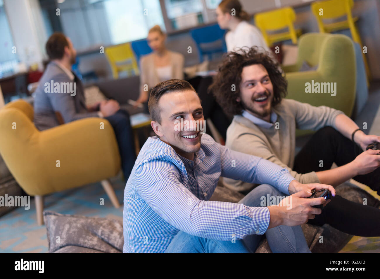 Work hard play hard. Workers Playing computer games in creative startup ...
