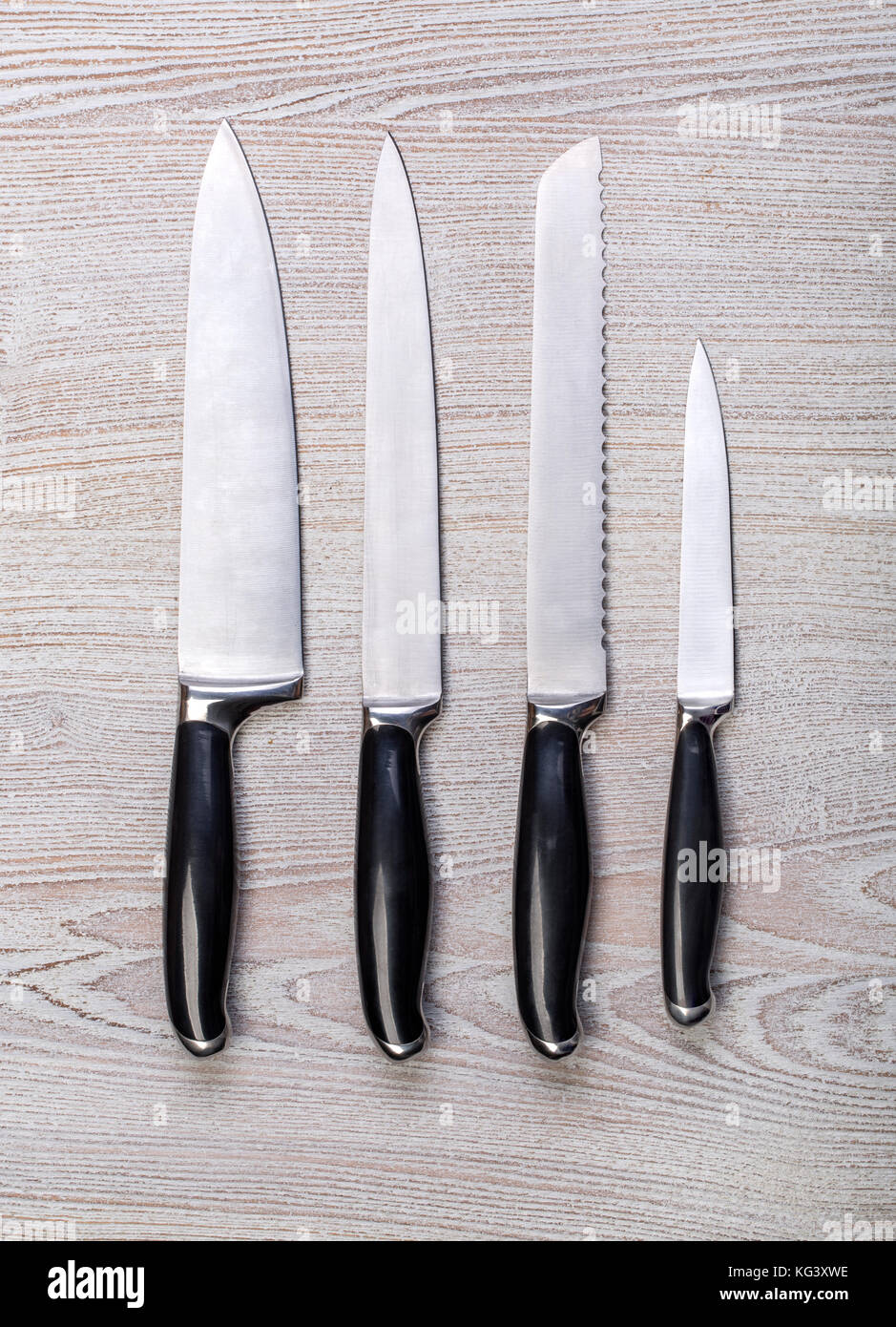 kitchen knifes over wooden table Stock Photo - Alamy