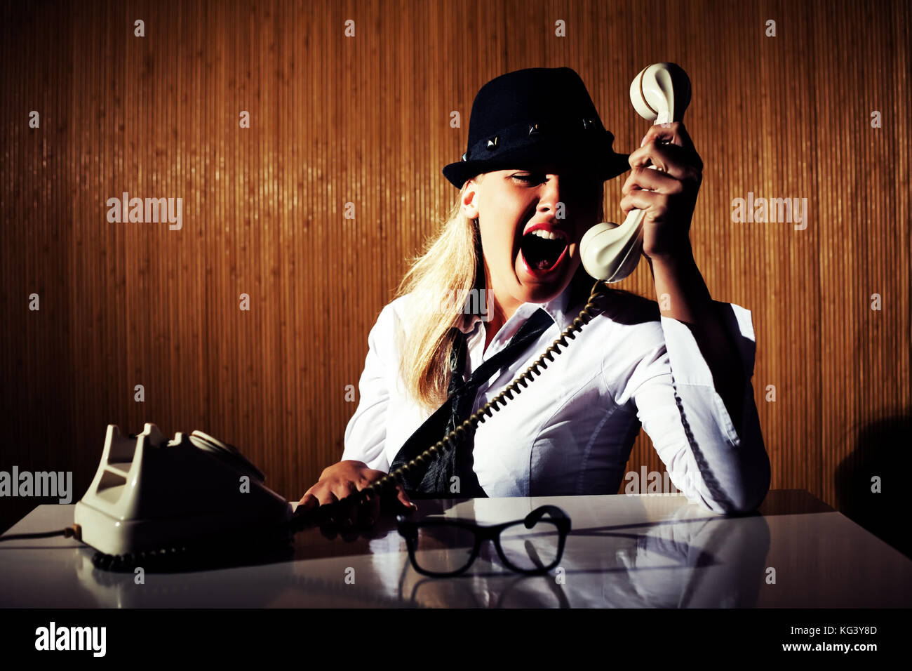 Retro styled businesswoman screaming on telephone in her office Stock ...
