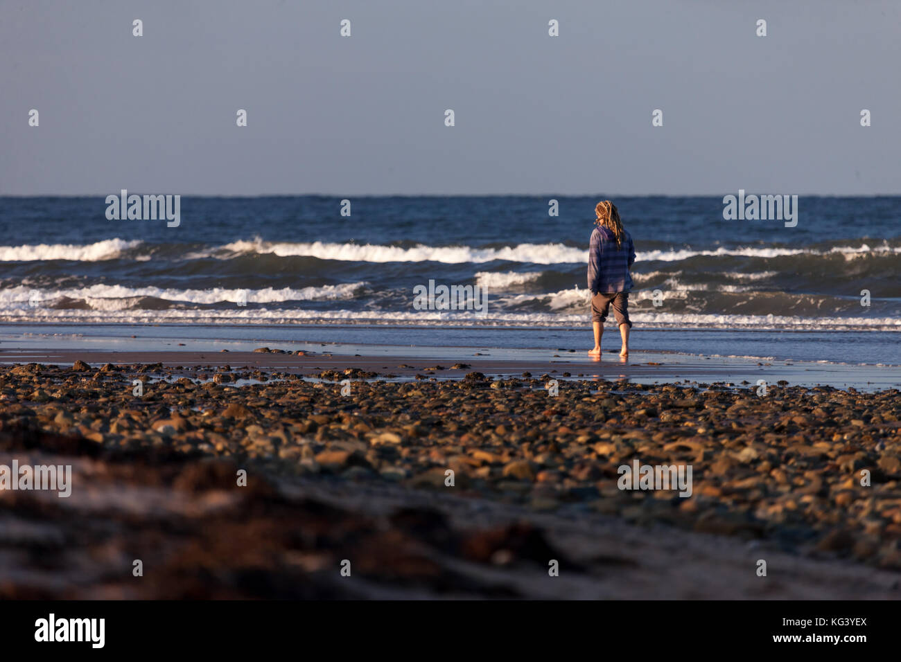 Antigonish County, Canada - August 28, 2017: A young man walks along a ...