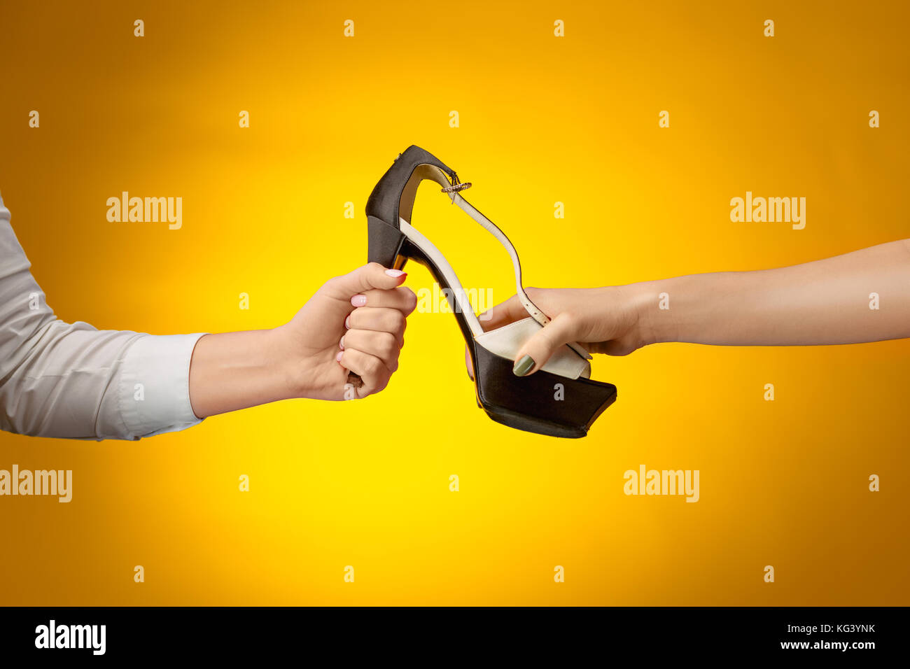 Brown woman shoe with female and male on hands Stock Photo - Alamy