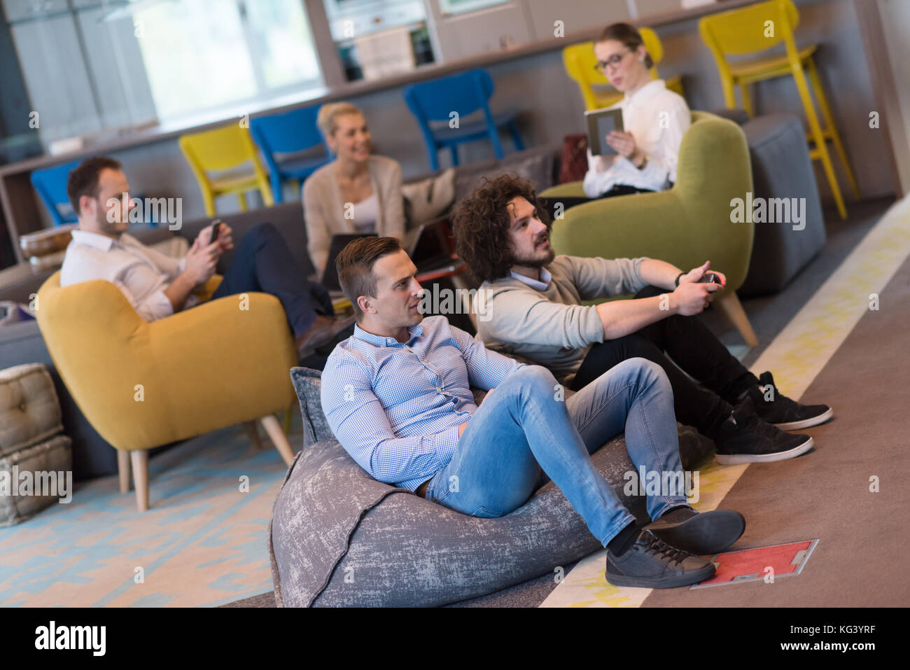 Work hard play hard. Workers Playing computer games in creative startup ...
