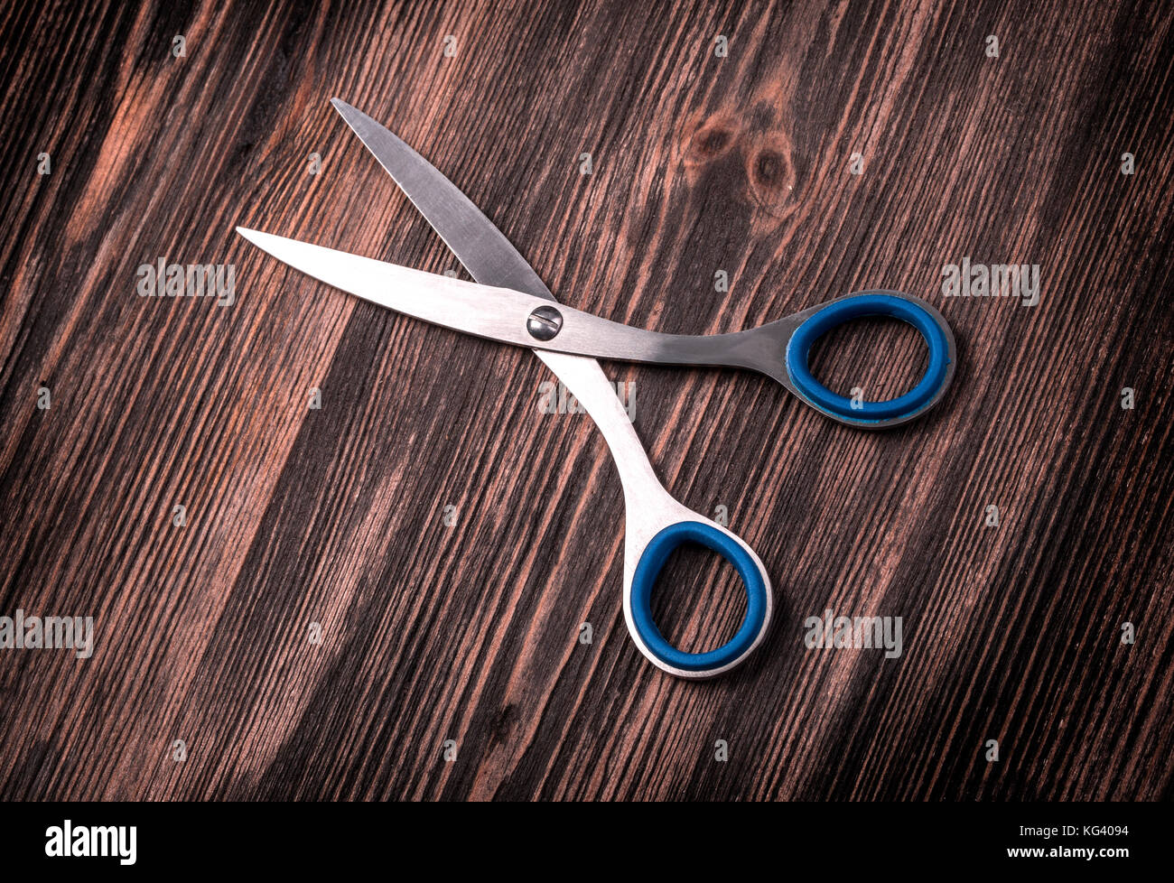 scissor on wooden board close up background Stock Photo - Alamy
