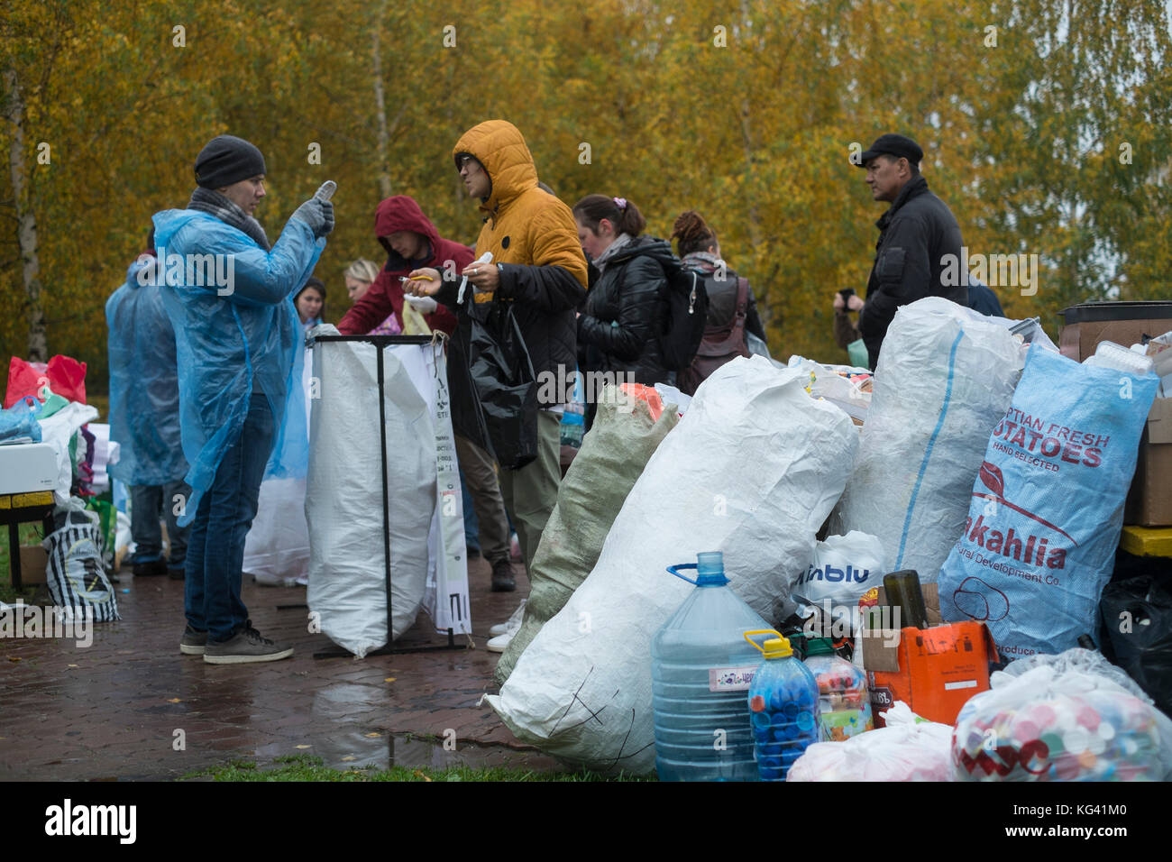 Volunteers collect household waste for recycling in a square in the ...