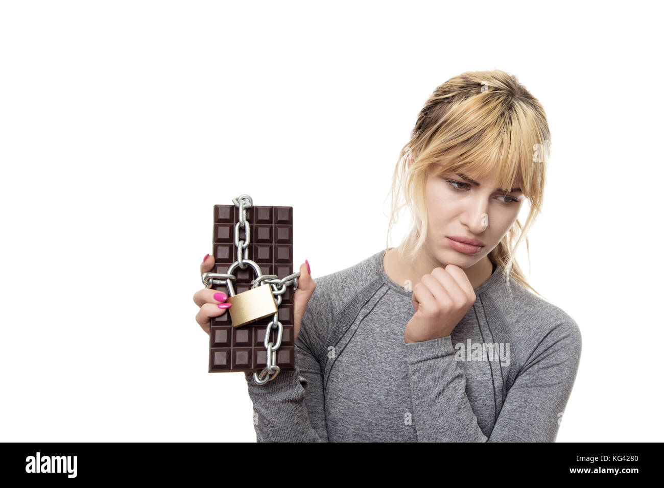 fitness woman holding a chocolate bar locked up in chains Stock Photo ...