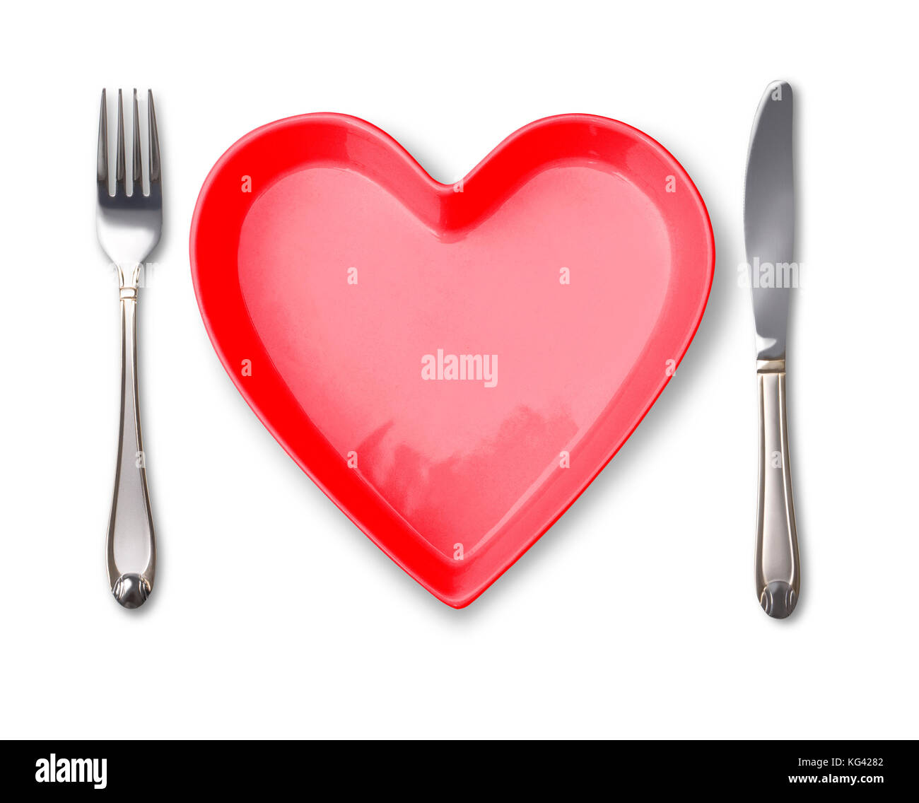 empty red heart plate with knife and fork on a white background Stock ...