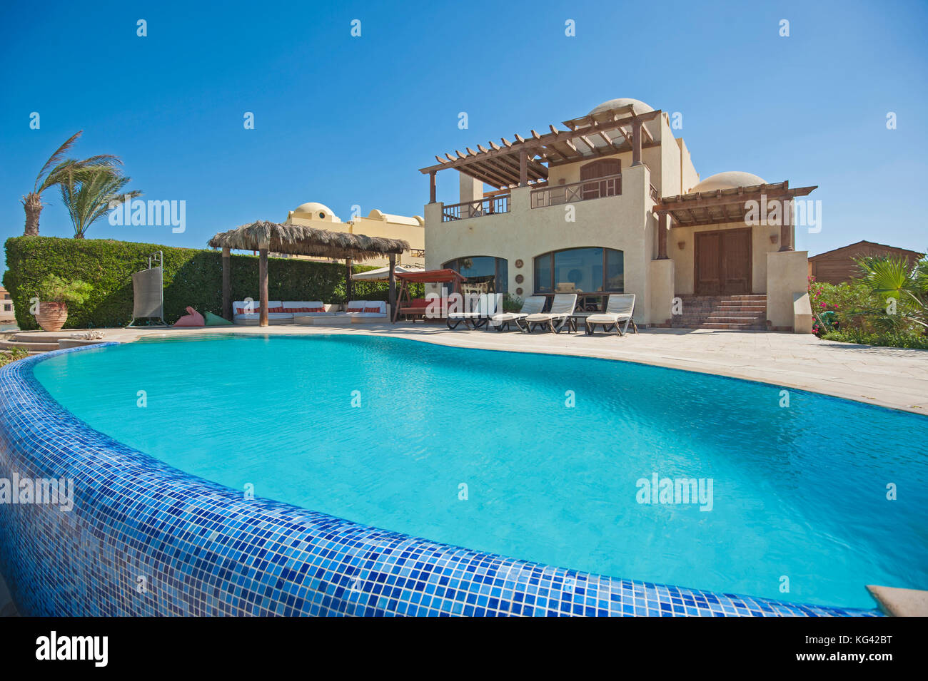 Luxury villa show home in tropical summer holiday resort with swimming ...