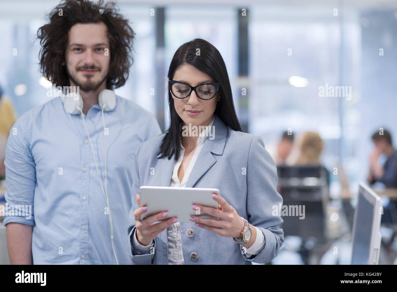 business people using tablet computer while preparing for next meeting ...