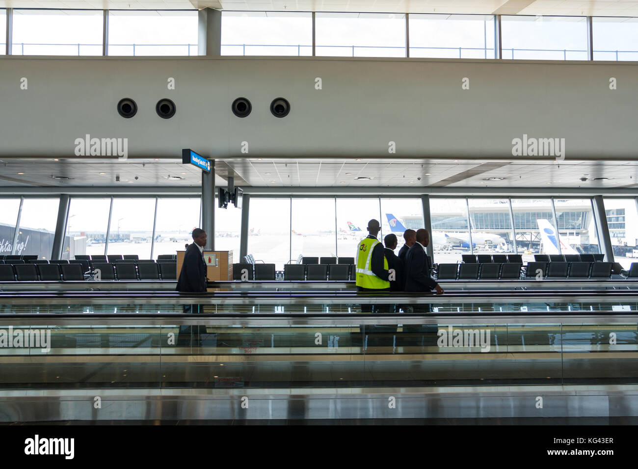 People on a moving walkway in the airport terminal, plane boarding ...