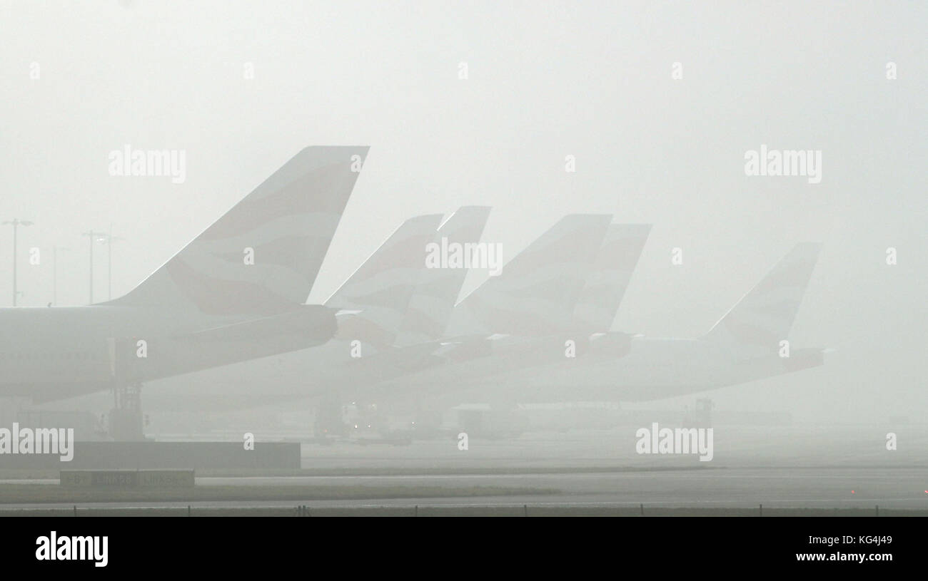 Planes are barely visible in the fog at Heathrow Airport's Terminal 5 ...