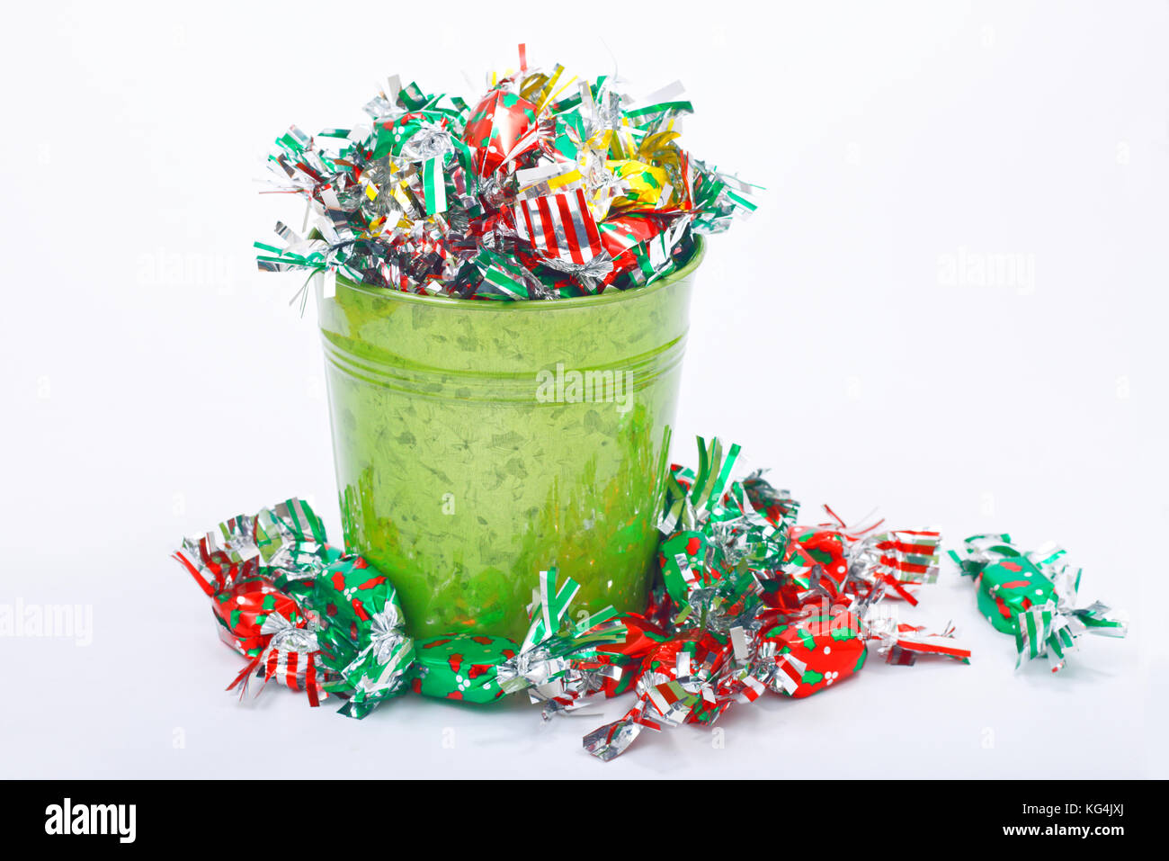 Colorful candy and green bucket on white background Stock Photo - Alamy