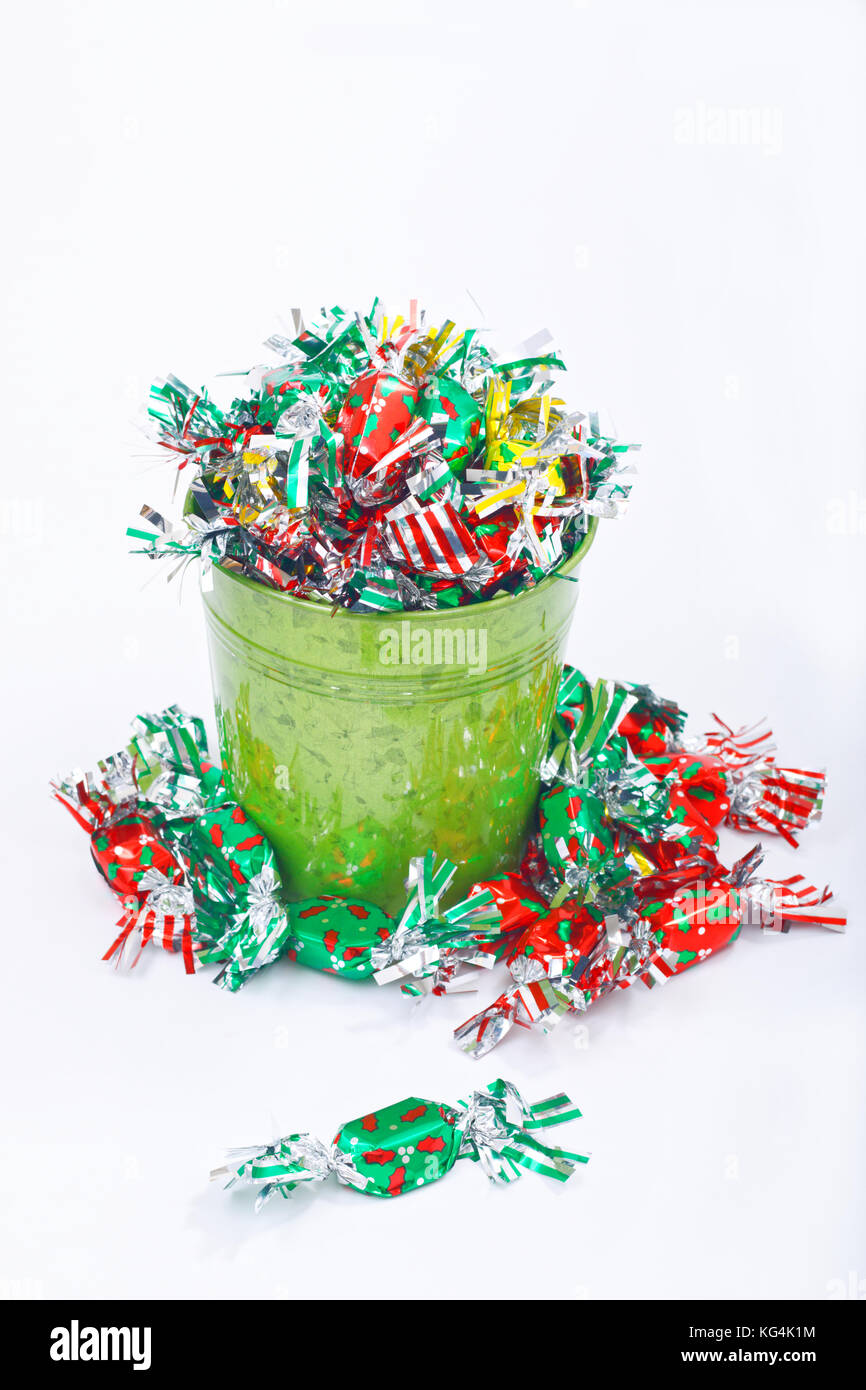 Colorful candy and green bucket on white background Stock Photo - Alamy