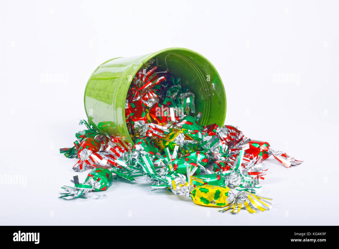 Colorful candy and green bucket on white background Stock Photo - Alamy