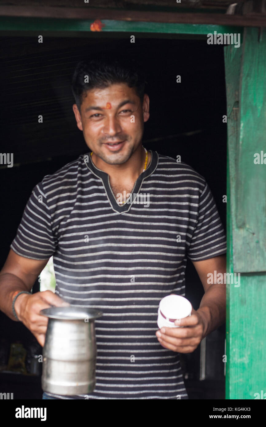 Man in doorway holding chai tea, Himalayas Stock Photo - Alamy