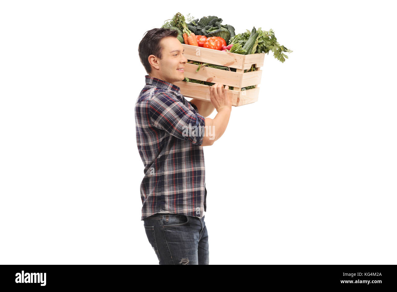 Farmer carrying a crate with fresh vegetables isolated on white ...