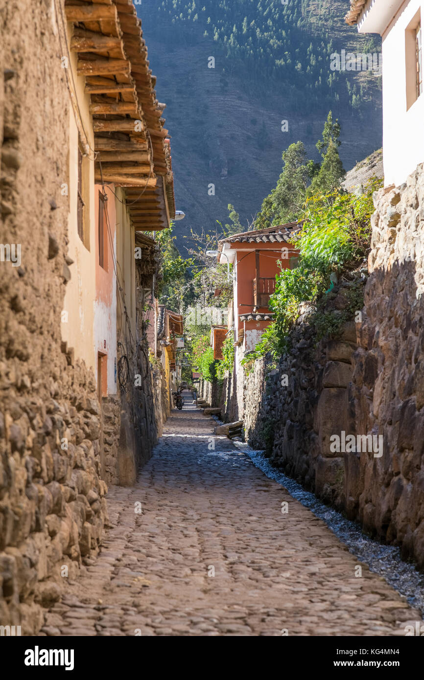 Old narrow street and brick buildings in Ollantaytambo Inca town Stock ...