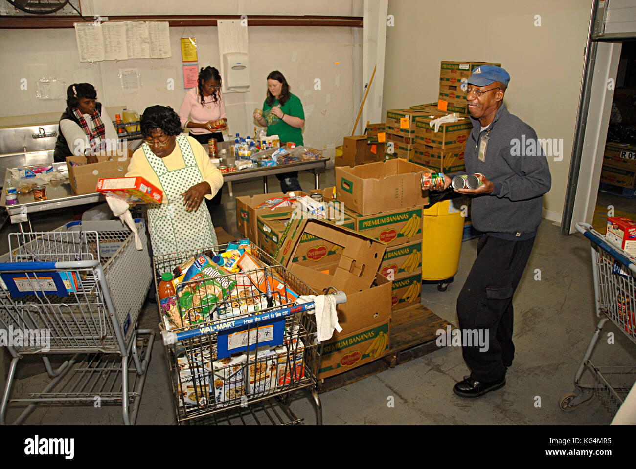 Volunteers sorting food items in Food Bank for distribution to churches ...
