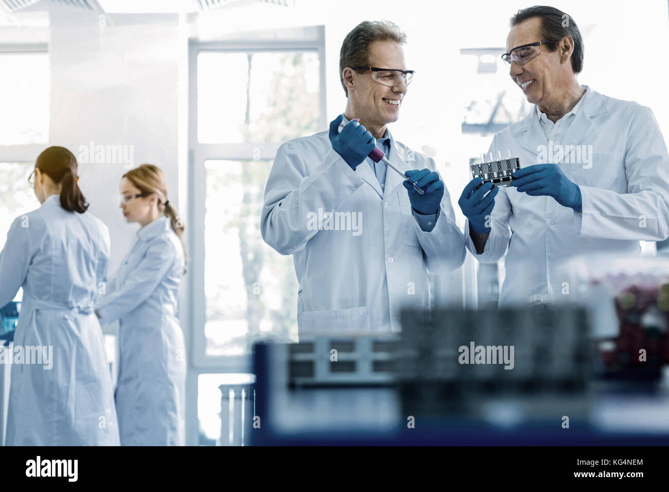 Joyful smart scientists working in team Stock Photo - Alamy