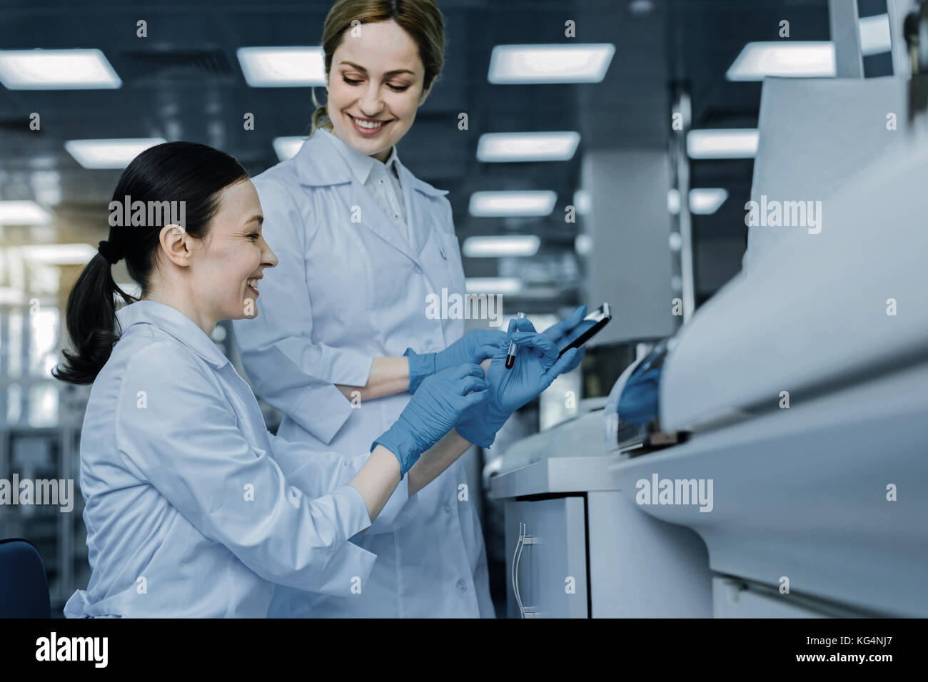 Happy nice women working together Stock Photo - Alamy
