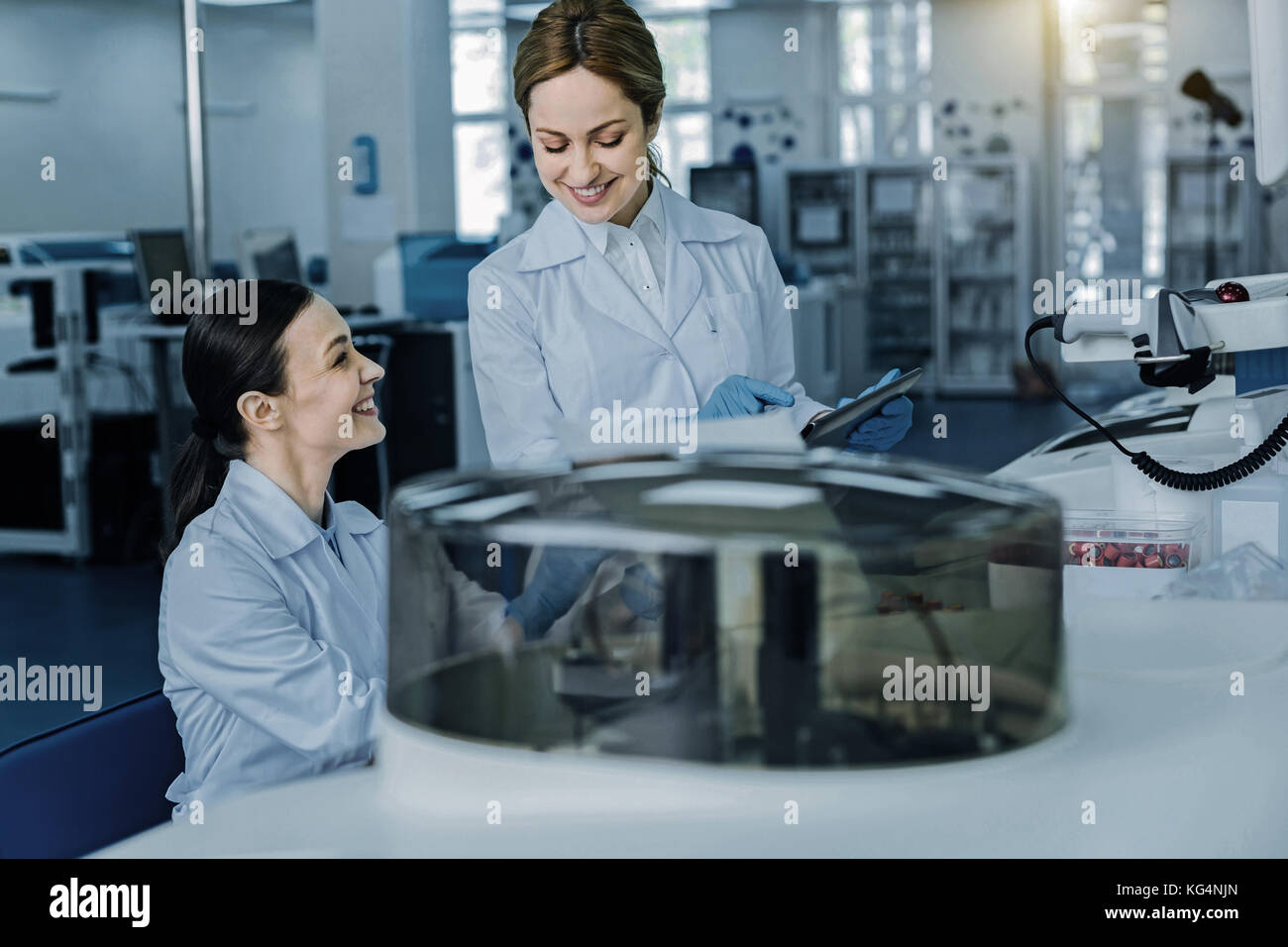 Cheerful happy scientists performing a test Stock Photo - Alamy