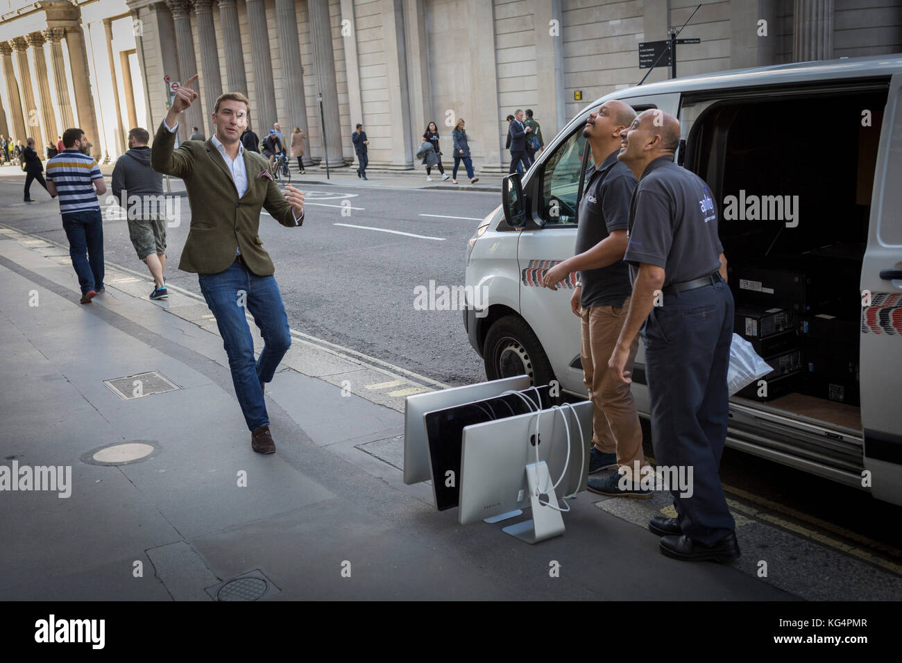Delivery men organise Apple Mac screens in the street, on 27th October ...