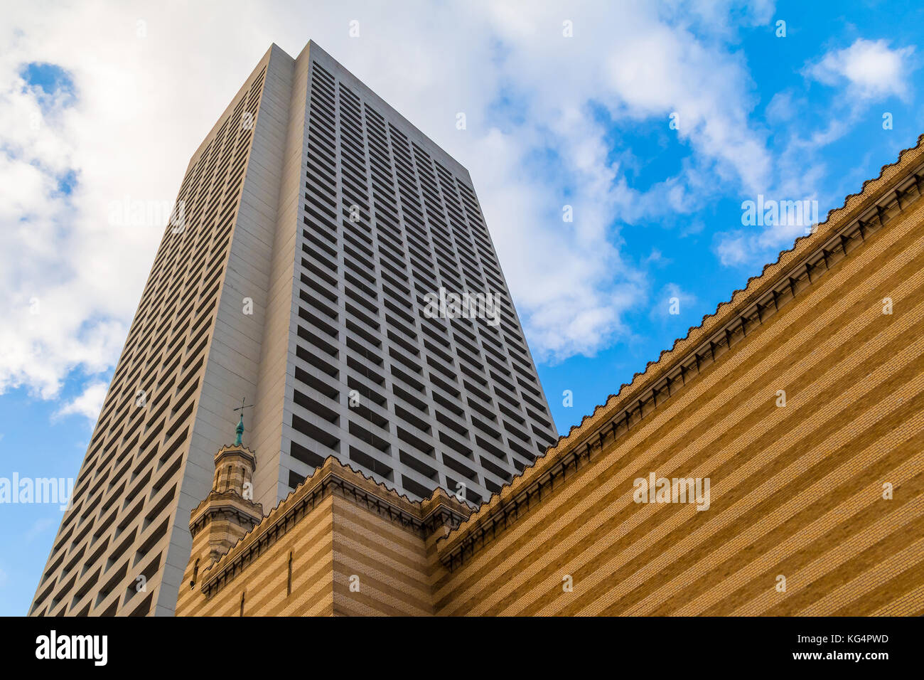 Bottom view of the skyscraper rising above the brick facade on the ...