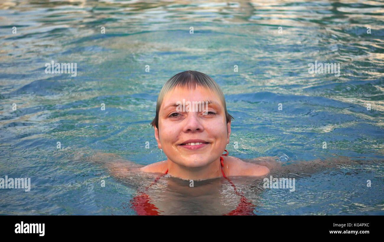 Woman emerging from pool hi-res stock photography and images - Alamy