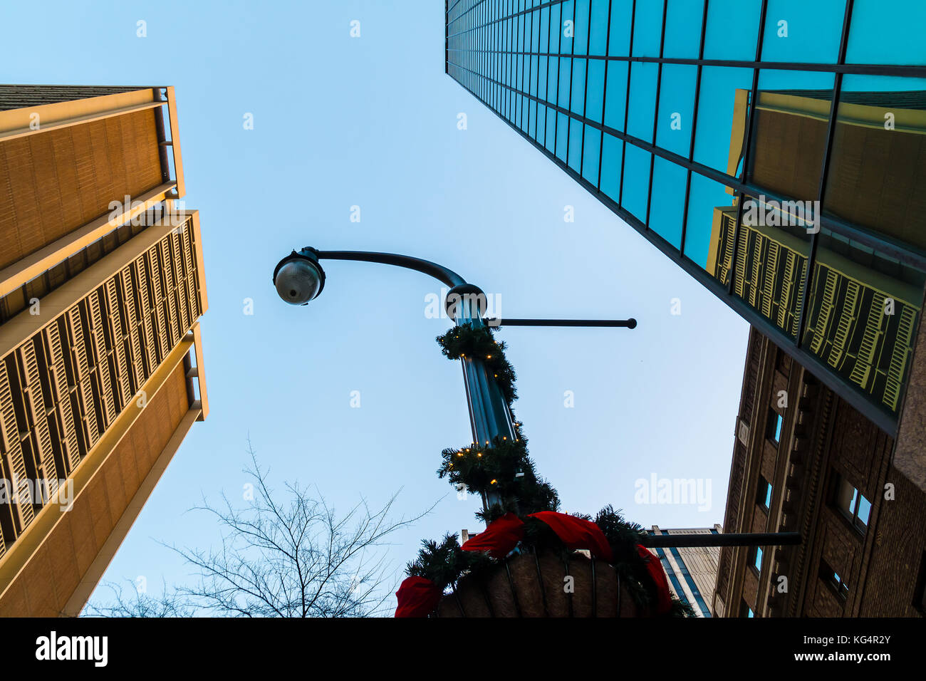 Bottom view of the skyscrapers and streetlight on the background of ...