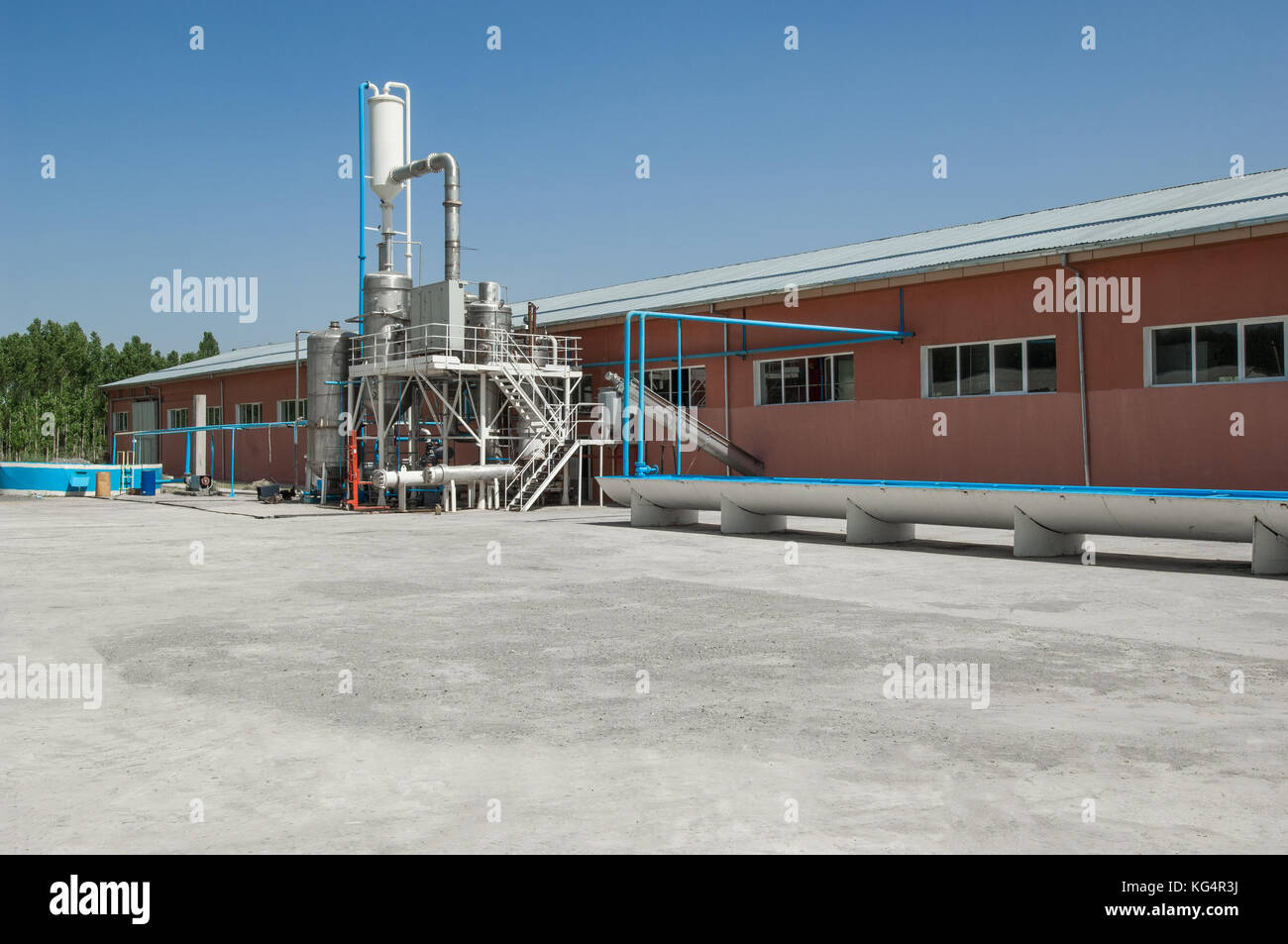 industrial one-story building with tanks and irrigation ditch Stock ...
